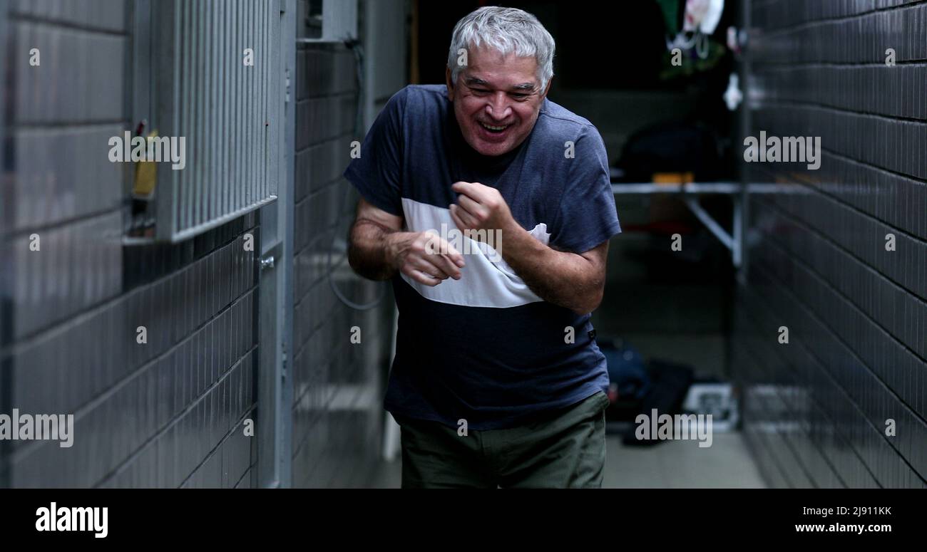 Casual old man doing funny funky dance. Senior celebrating success ...