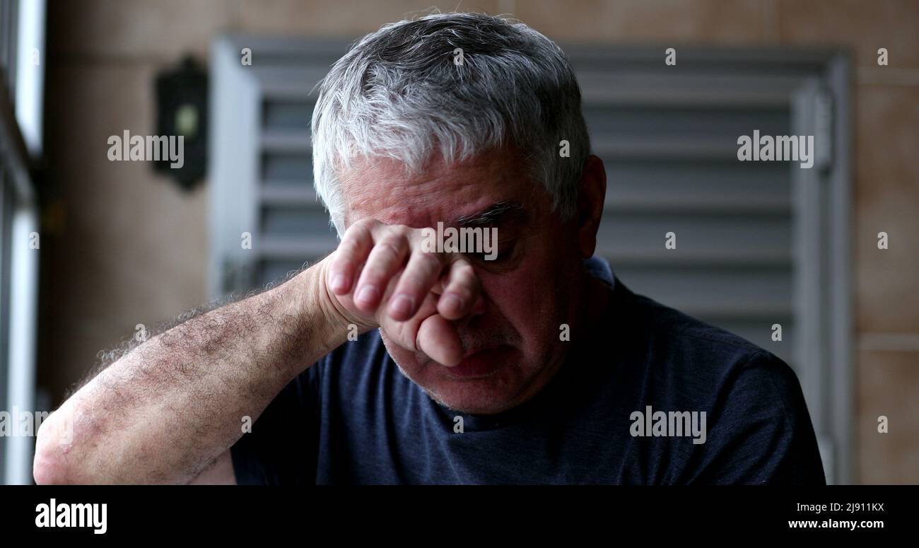 Angry sad middle aged man crying wiping tears Stock Photo - Alamy