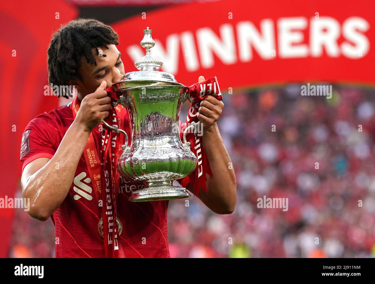 Liverpool's Trent Alexander-Arnold kisses the trophy following the ...