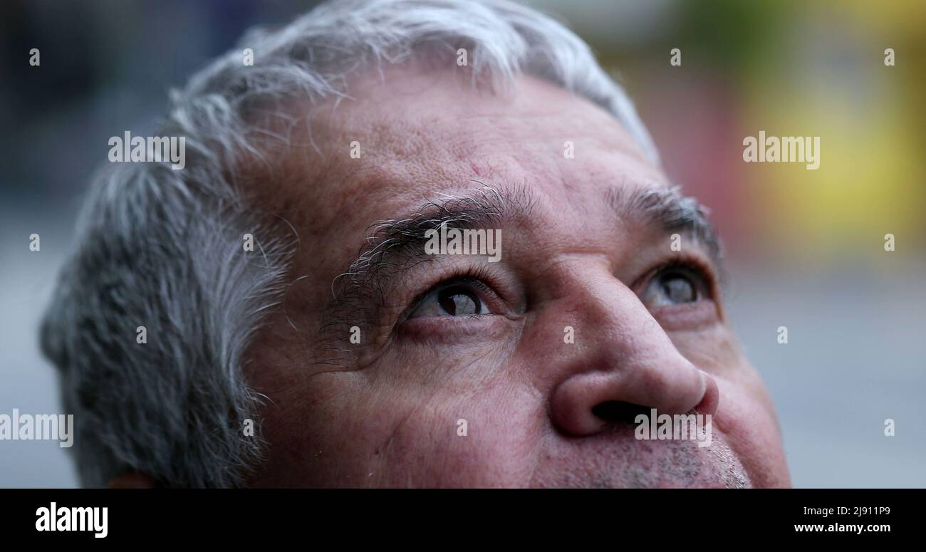 Close-up old man eyes looking up to sky with FAITH Stock Photo - Alamy