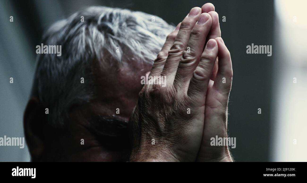 Dramatic serious older man praying to God Stock Photo - Alamy