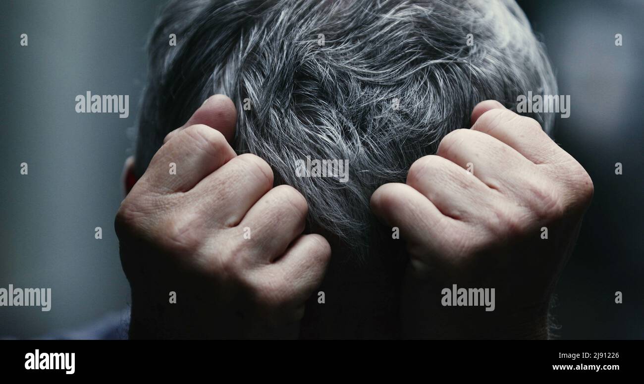 Dramatic depressed older man in agony. 60 year old man suffering mental ...