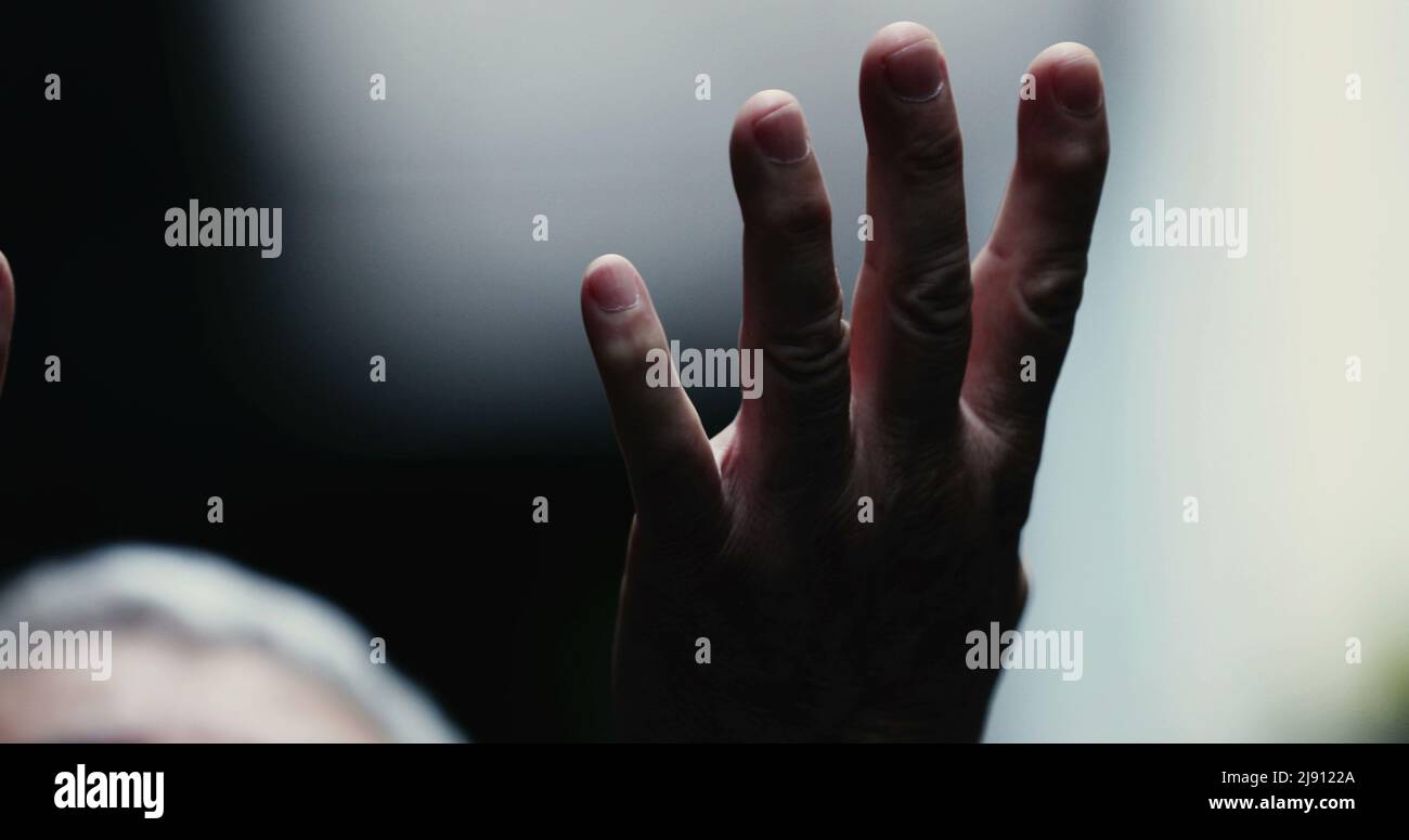 Dramatic person raising hands into sky asking for help Stock Photo - Alamy