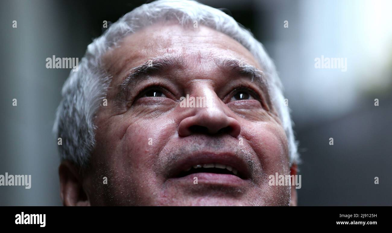 Hopeful old man looking at sky with FAITH Stock Photo - Alamy