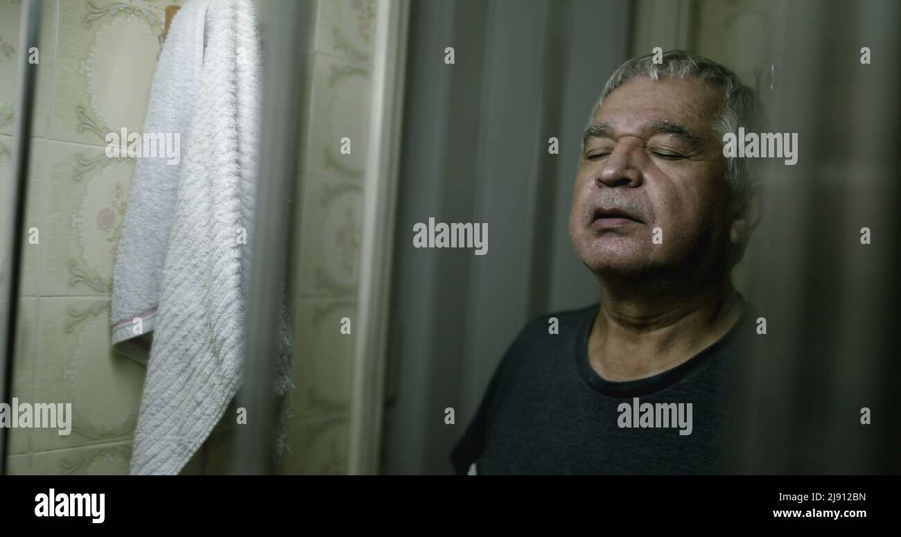 Old man closing eyes trying to concentrate and to calm down during ...