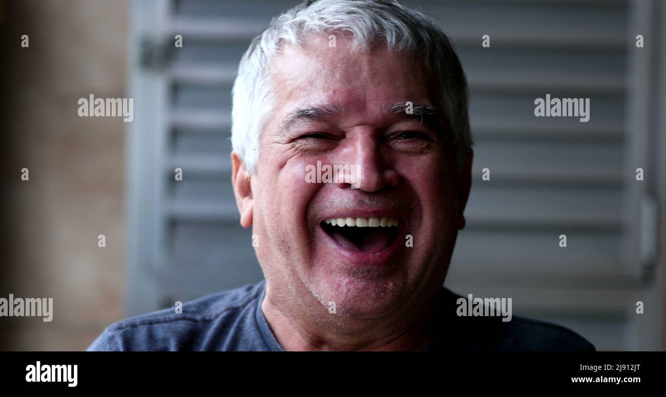 Older man laughing uncontrollably, happy person in 60s laugh out loud ...