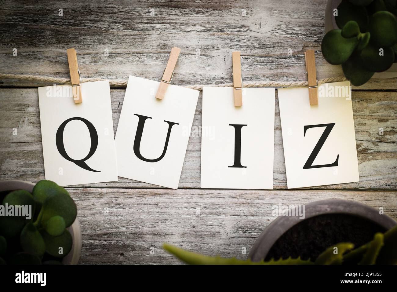 A set of printed cards spelling the word QUIZ on an aged wooden ...