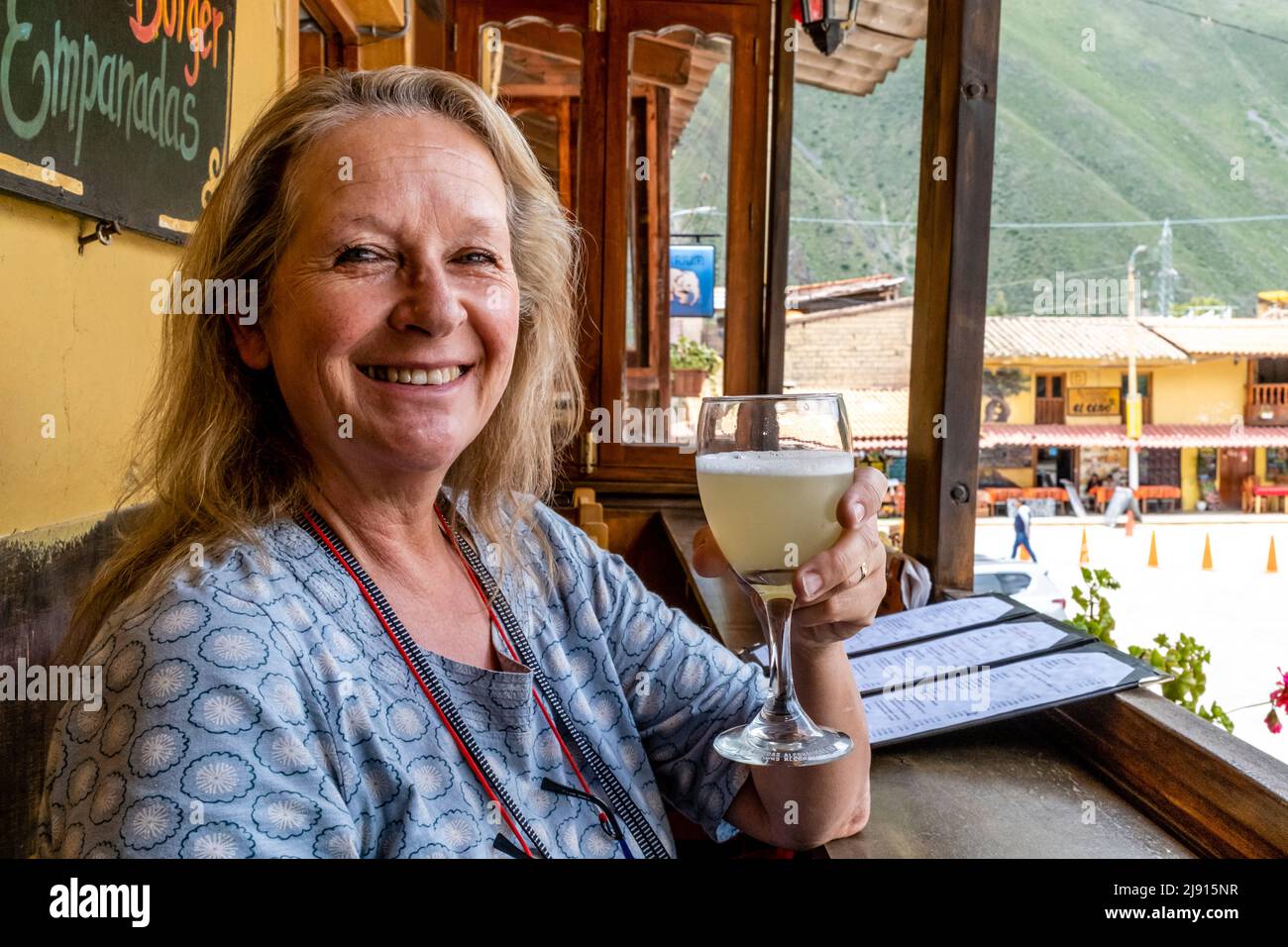 A Mature Woman Drinking A Traditional Pisco Sour At A Bar/Restaurant In ...