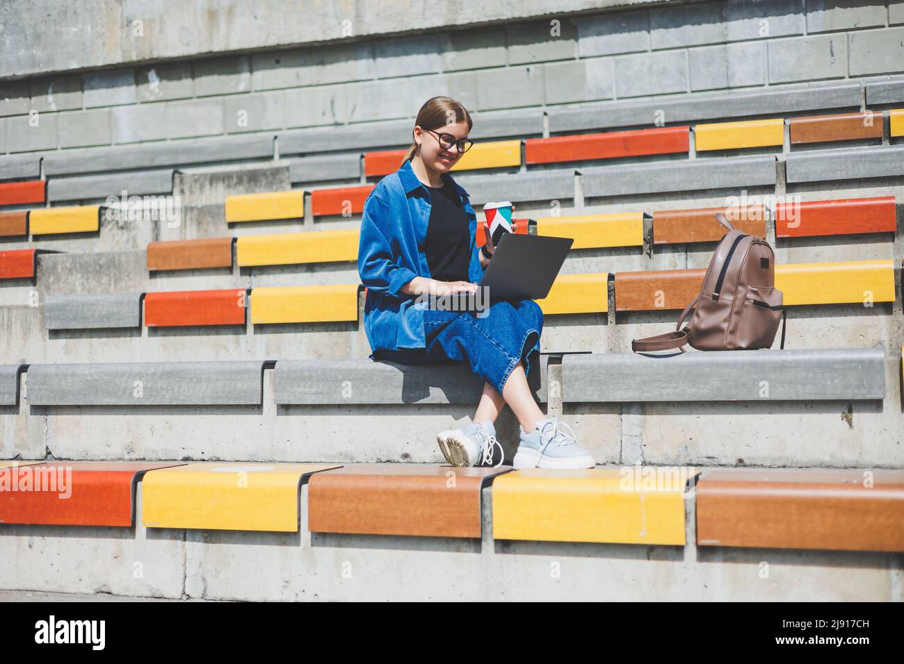 Image of joyful brunette woman walking against beige wall outdoor and ...