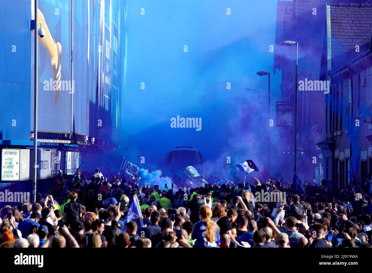 Everton fans light flares and line the streets as the team bus arrives ...