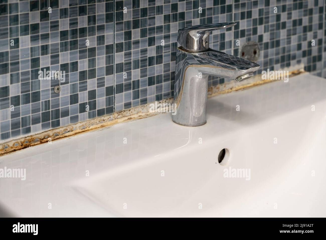 Mold and rust growing in tile joints in a damp poorly ventilated ...