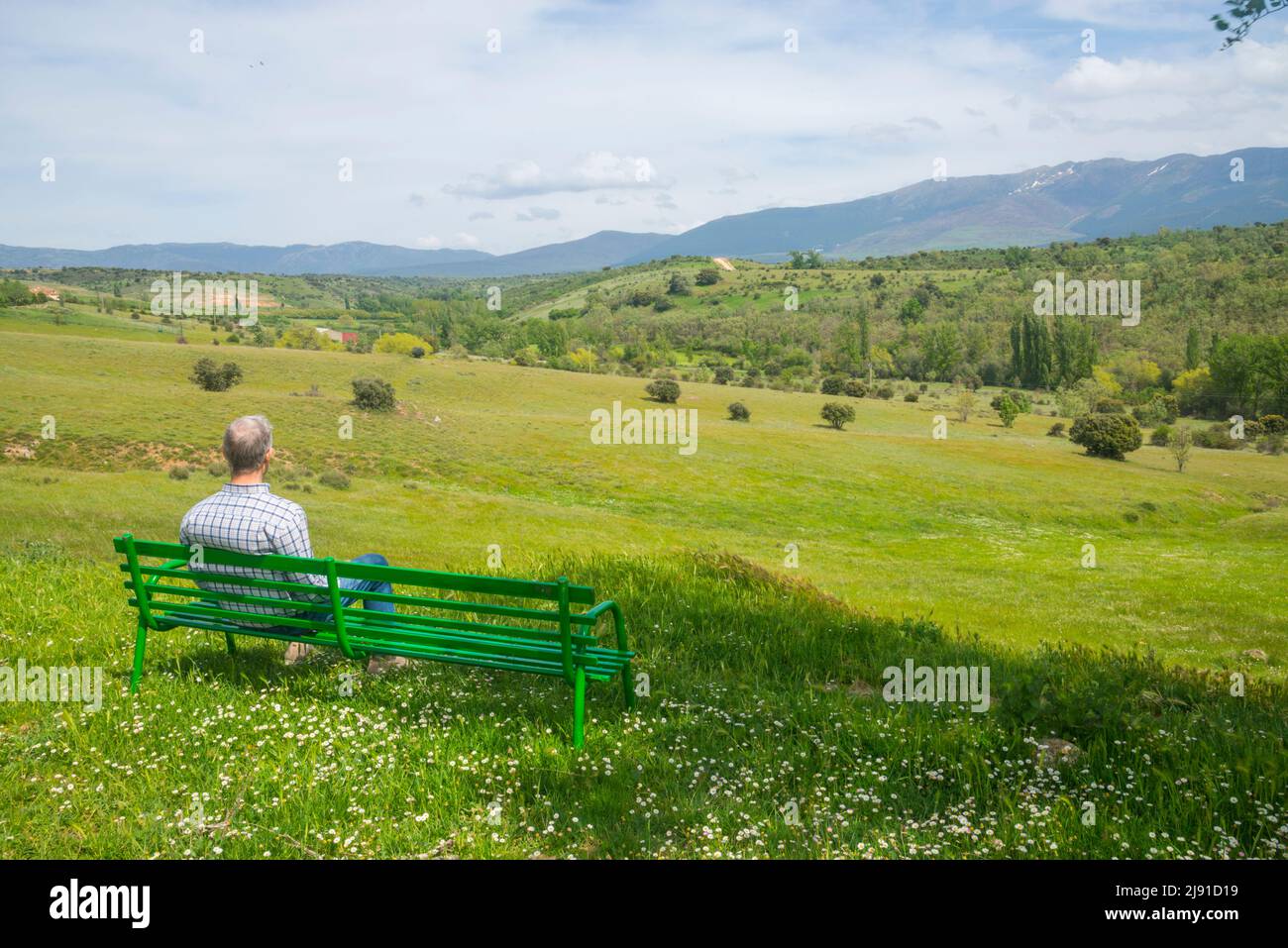 Man sitting on a bench in the countryside Stock Photo - Alamy