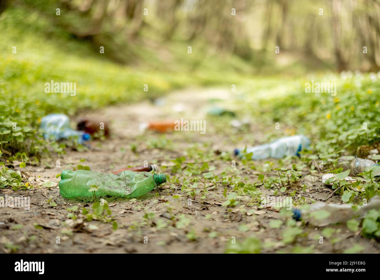 Scattered plastic garbage on nature Stock Photo - Alamy