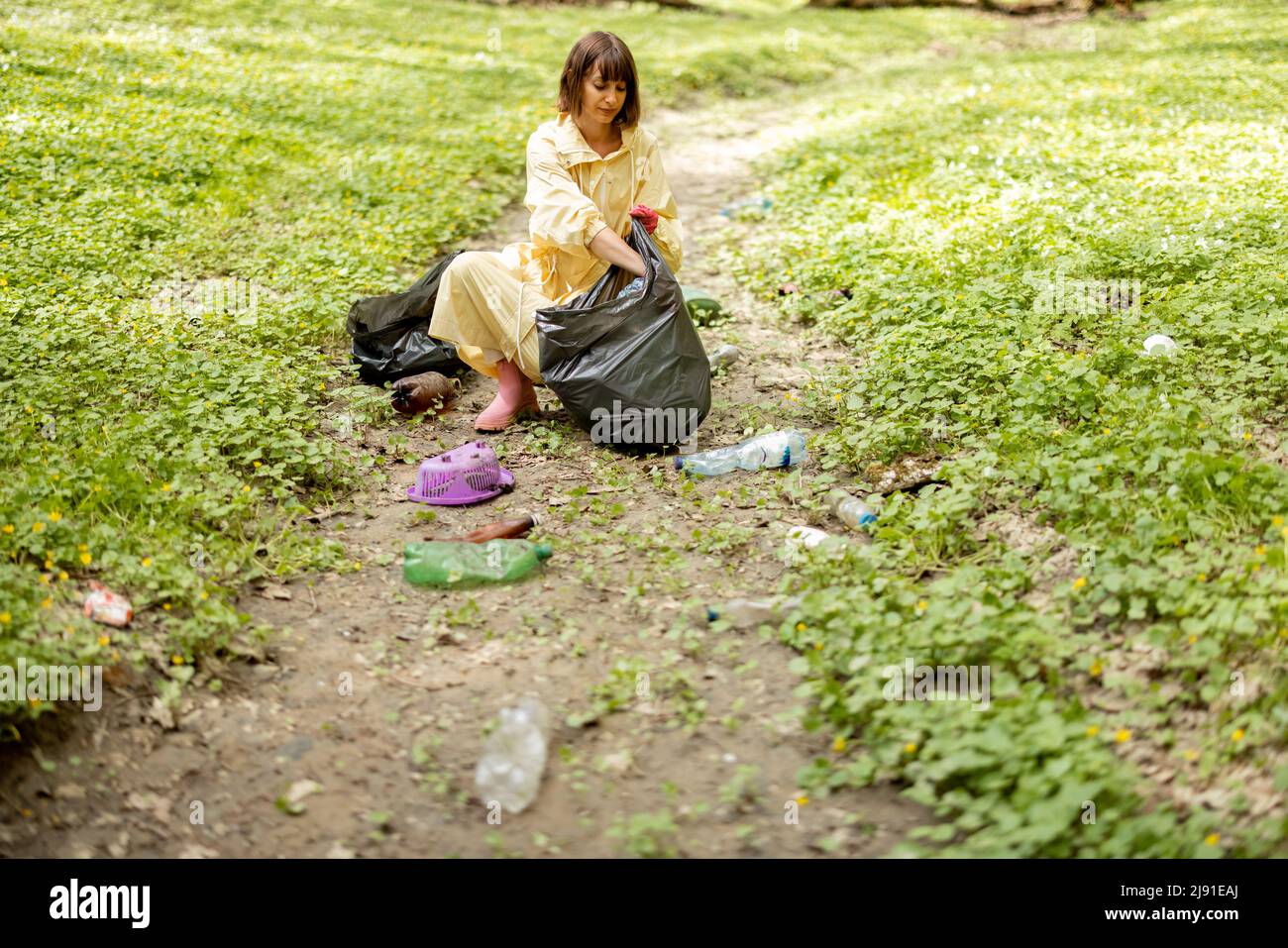 Woman picking garbage hi-res stock photography and images - Alamy