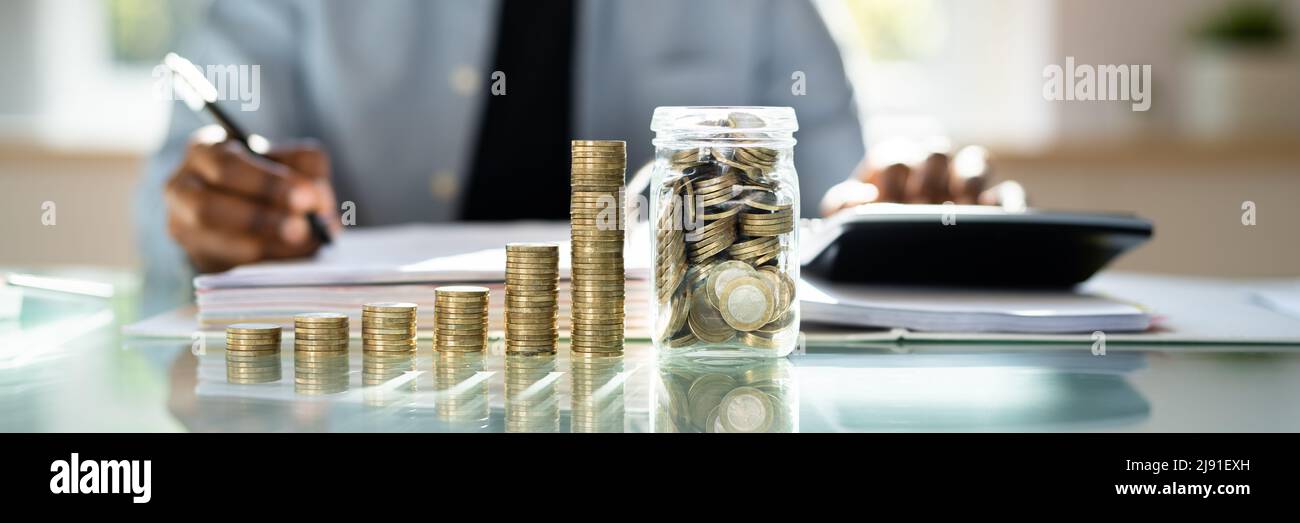 African Accountant Using Calculator. Tax Money And Coins Stock Photo ...