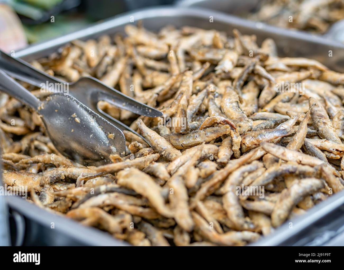 Delicious Fried anchovy small fish for sale. Fresh salty dish Stock ...