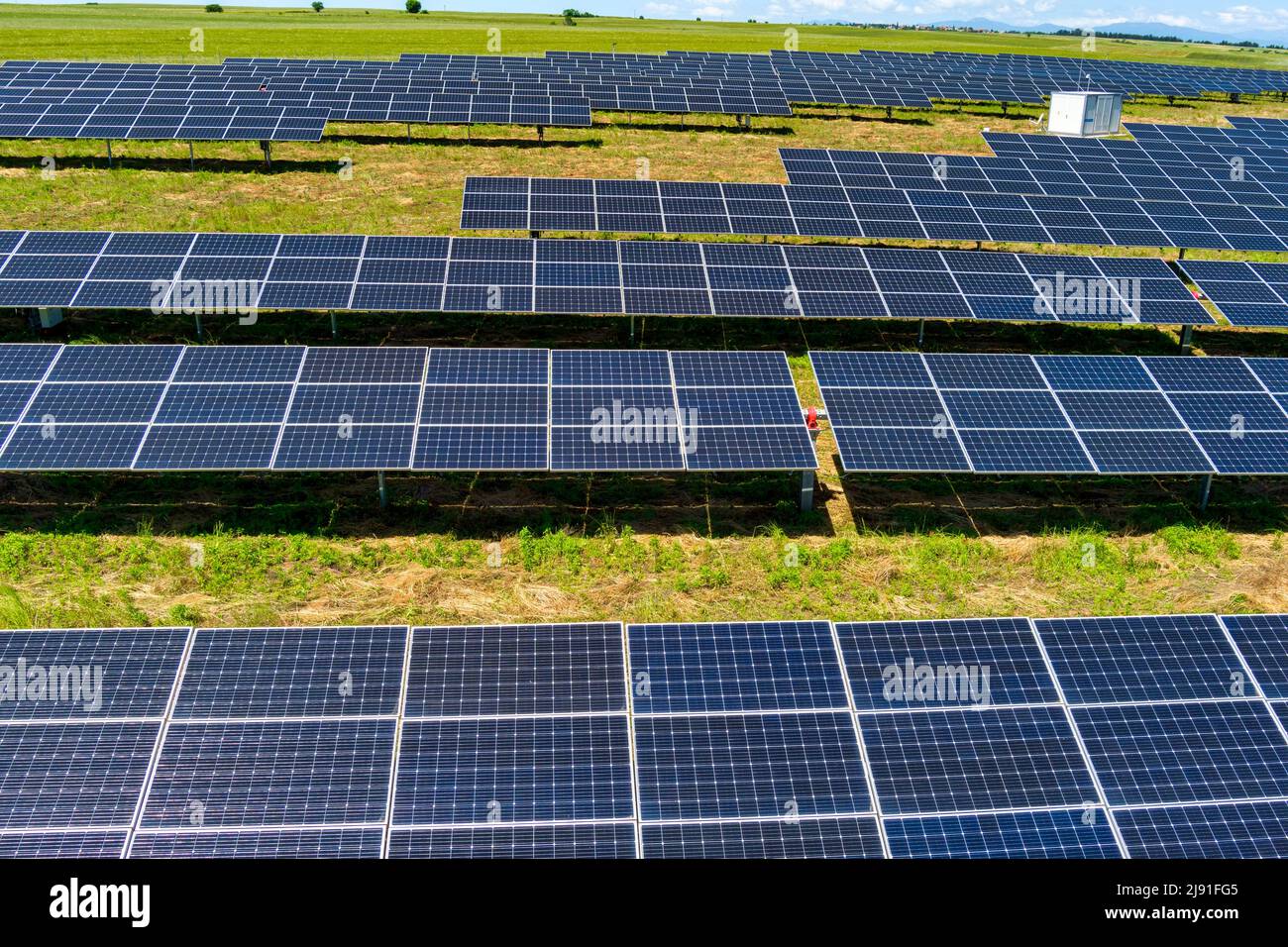 Aerial view photovoltaic panels park on green field in north Greece ...