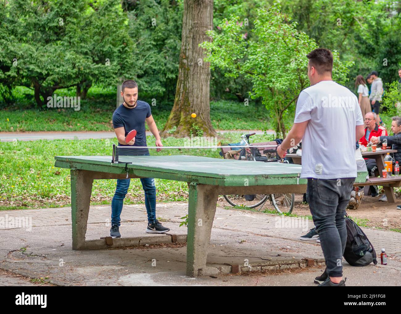 Bucharest, Romania - 04.15.2022: People playing tennis table or ping-pong in King Mihai I park ...