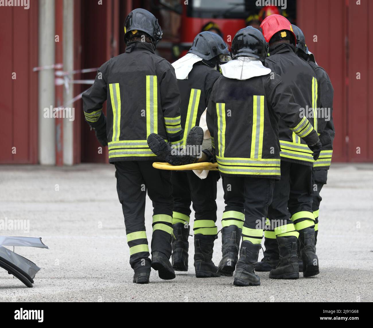 group of firefighters who help the injured person after the road ...