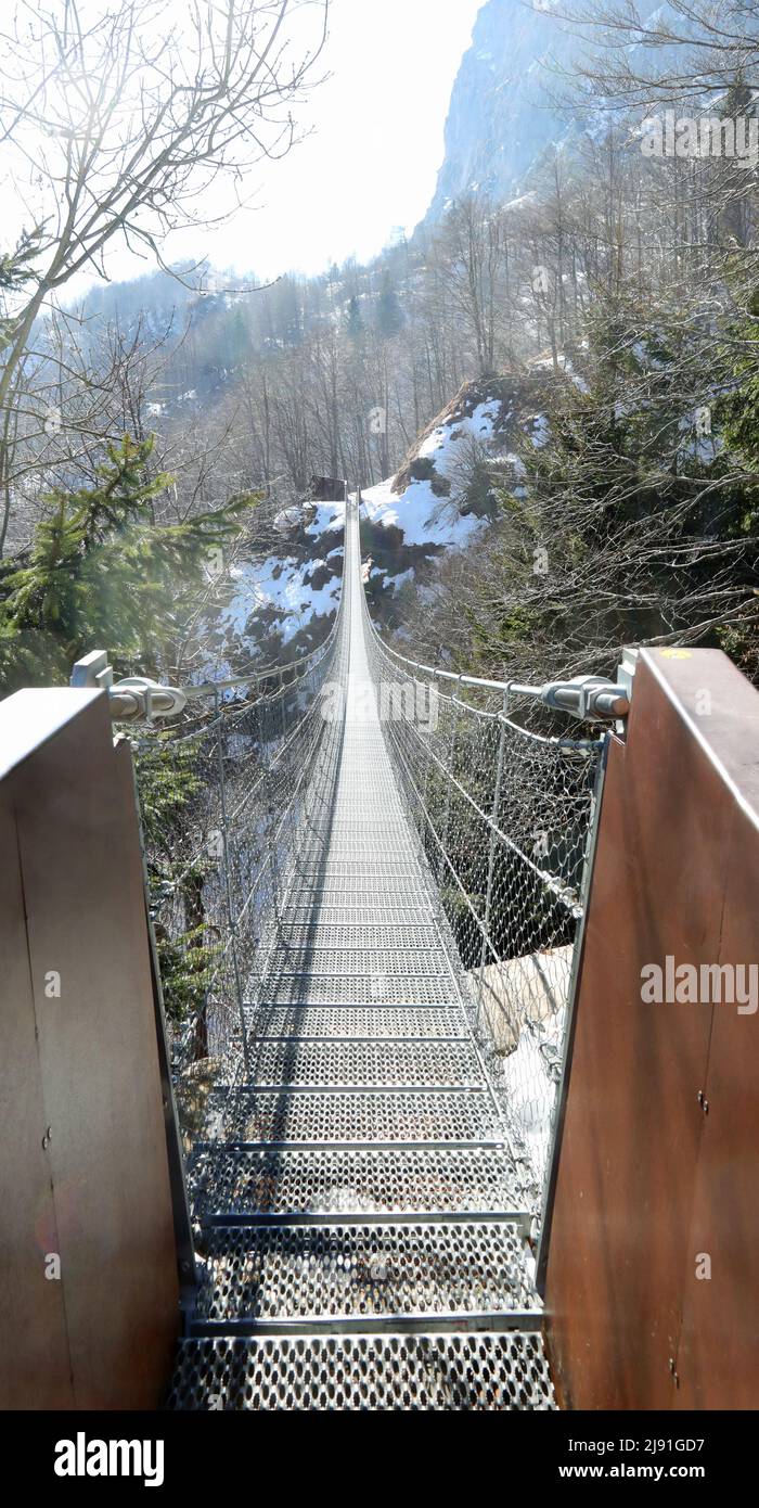 along the suspension bridge made of sturdy steel ropes that connects ...