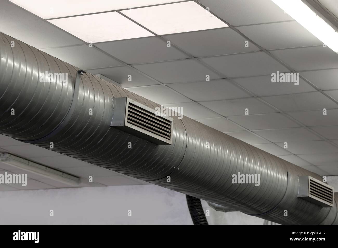 large pipe of the air conditioning system in the industrial warehouse ...