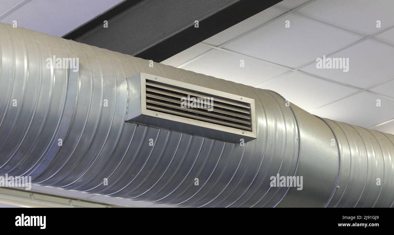 large pipe of the air conditioning system in the factory and the nozzle ...