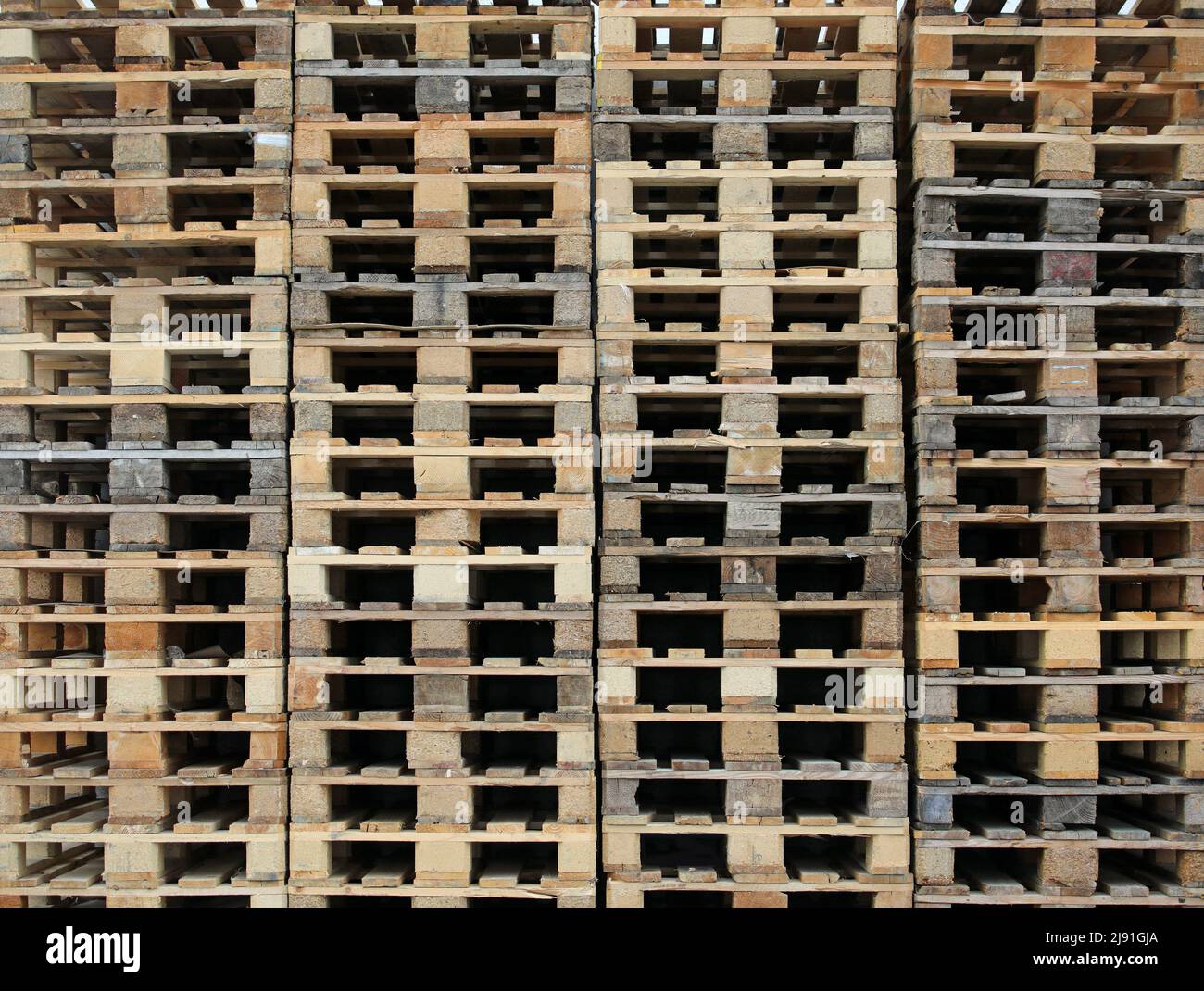 background of hundreds of wooden pallets in the warehouse of the ...
