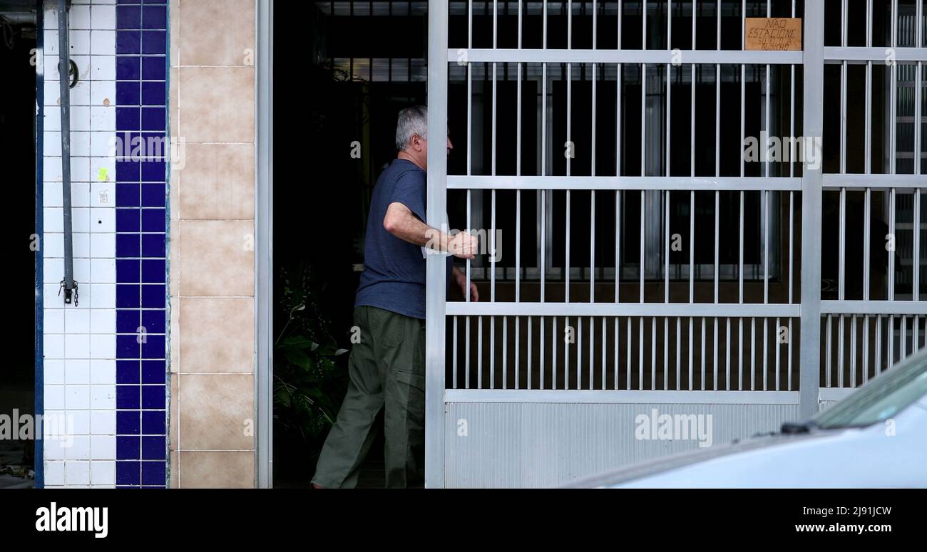 Older man opening metal gate hi-res stock photography and images - Alamy