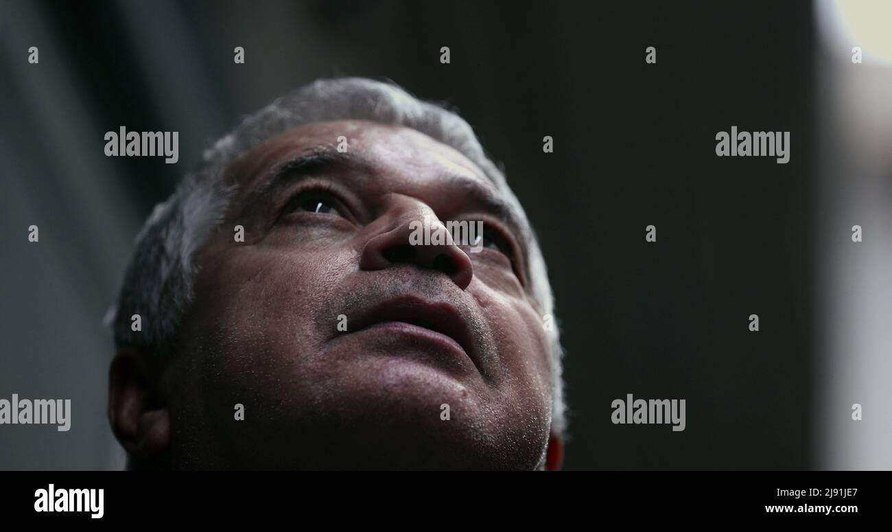 Older man face looking at sky with hope and faith Stock Photo - Alamy