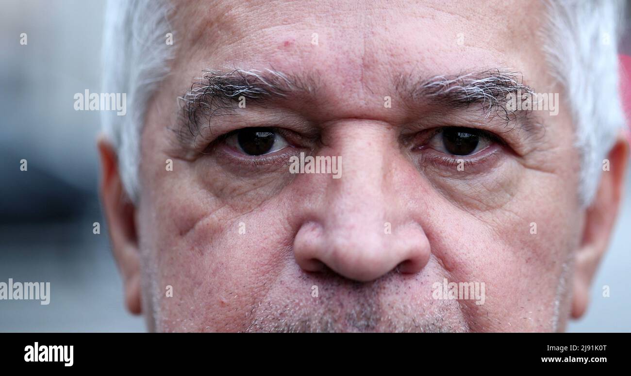 Wrinkled middle-aged man close-up eyes staring camera Stock Photo - Alamy