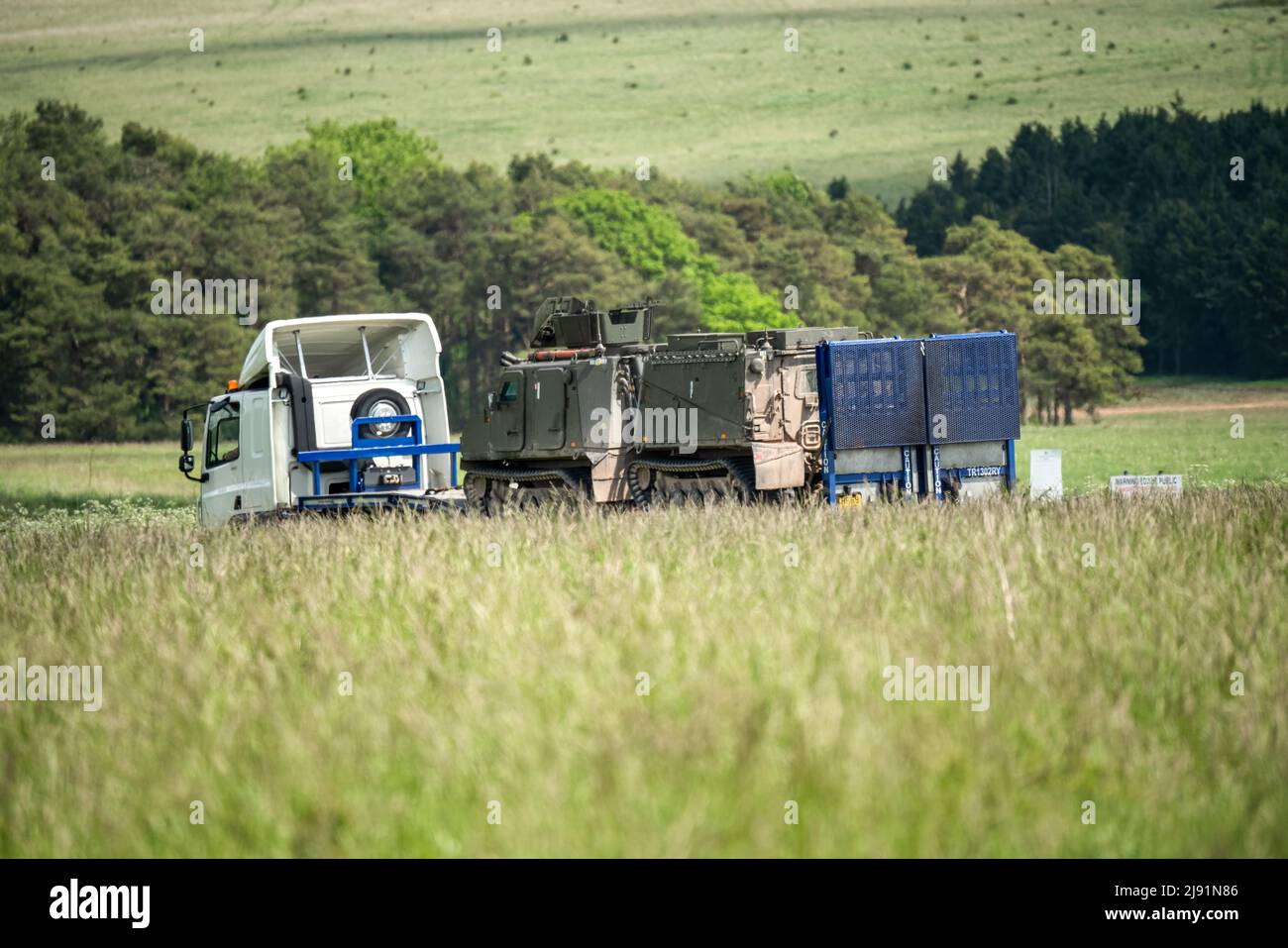 Flatbed low-loader transporter truck carrying a British Army BvS10 ...