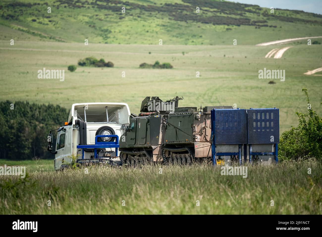 Flatbed low-loader transporter truck carrying a British Army BvS10 ...