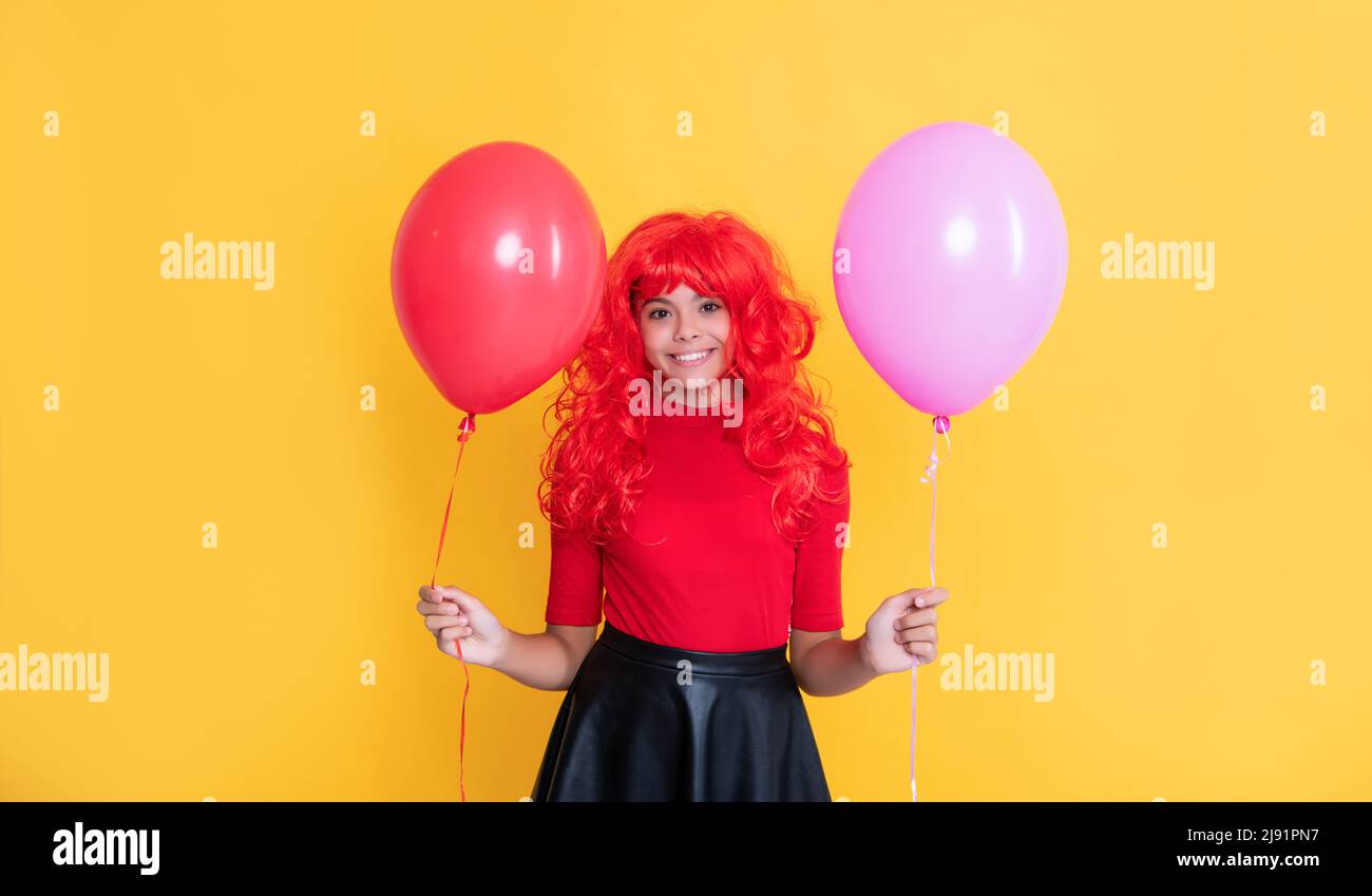 positive teen child with party balloon on yellow background Stock Photo ...