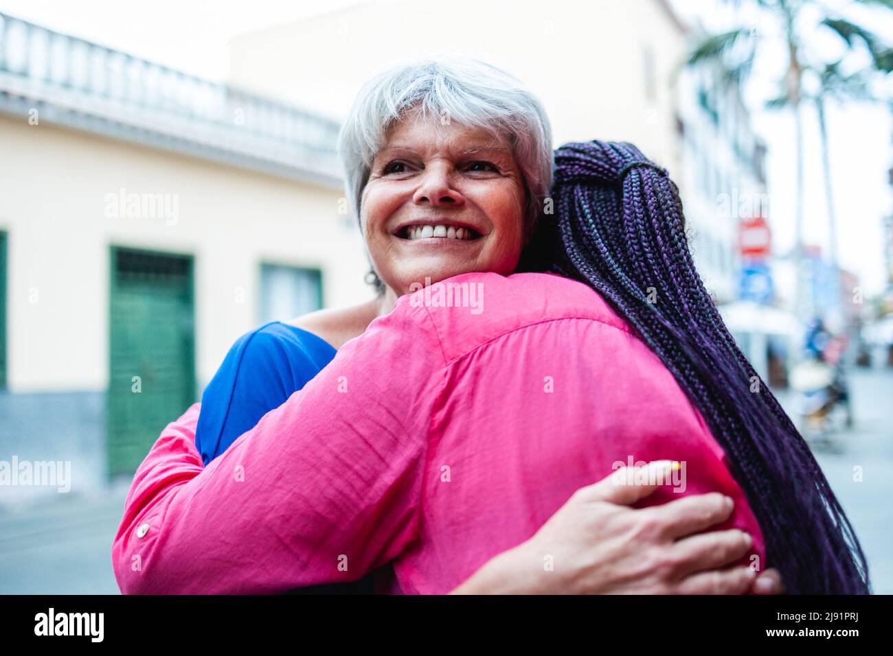 Multiethnic senior women hugging each other - Elderly diverse community ...