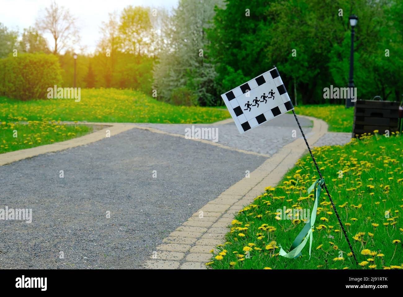 City marathon running track sign in the city park. Flags indicating the ...
