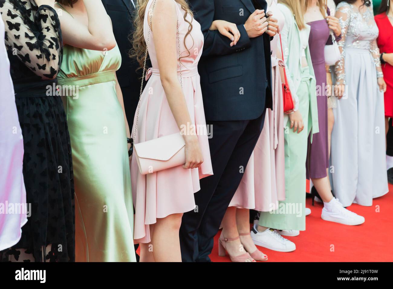 Prom guests standing on a red carpet, close up photo Stock Photo - Alamy