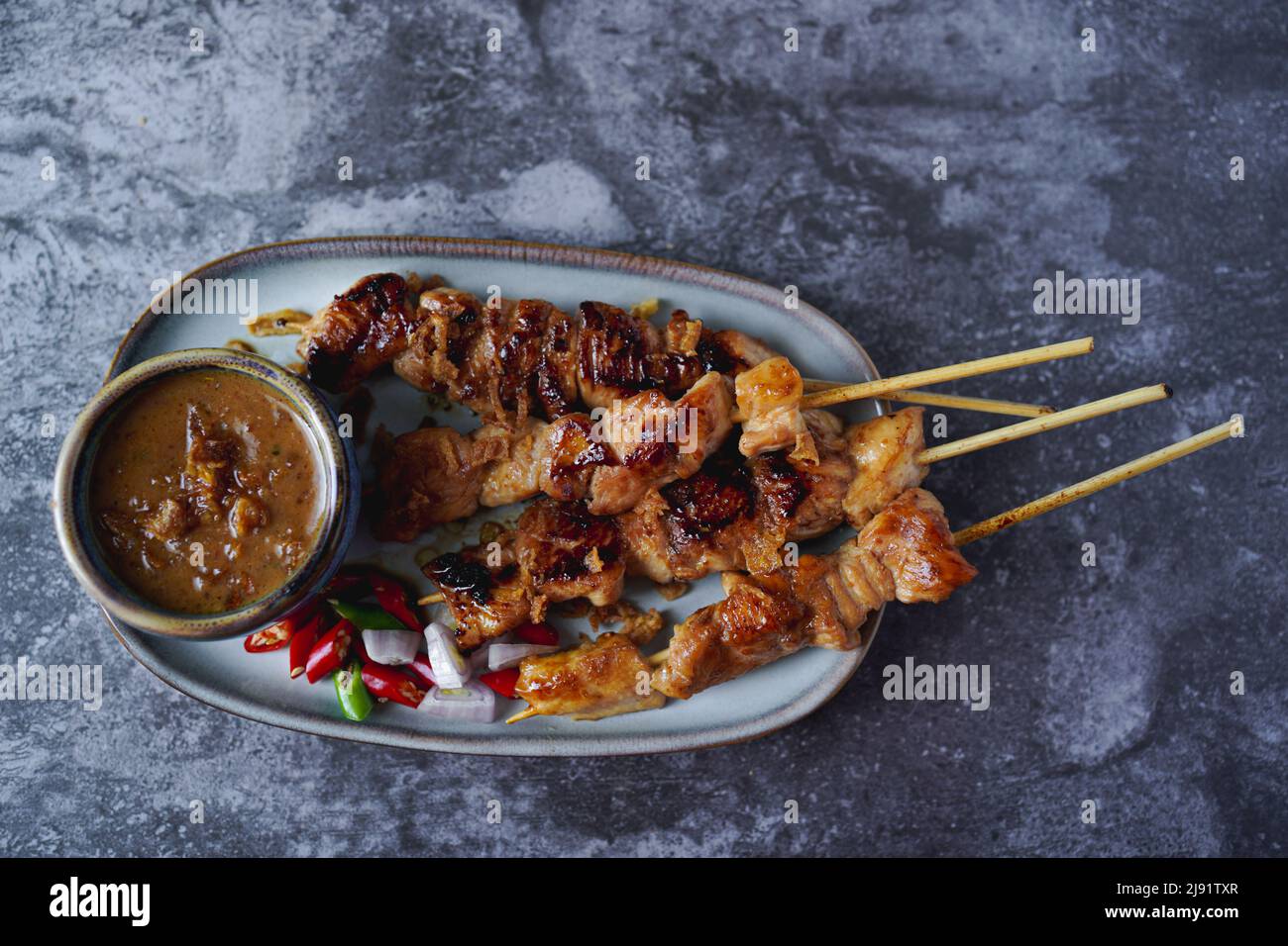 Indonesian chicken satay served with peanuts sauce Stock Photo - Alamy