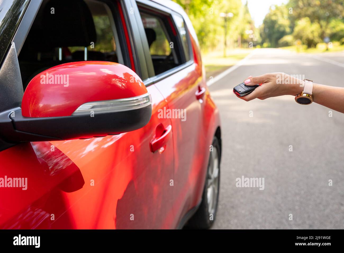 women hand presses on the remote control car alarm systems Stock Photo ...