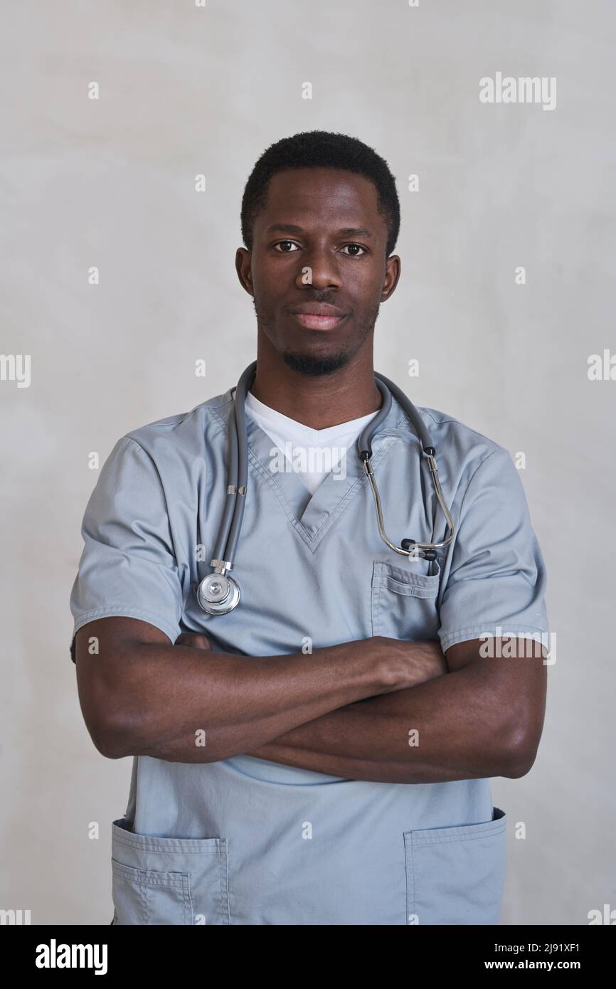 Vertical medium portrait shot of handsome Black doctor wearing gray ...