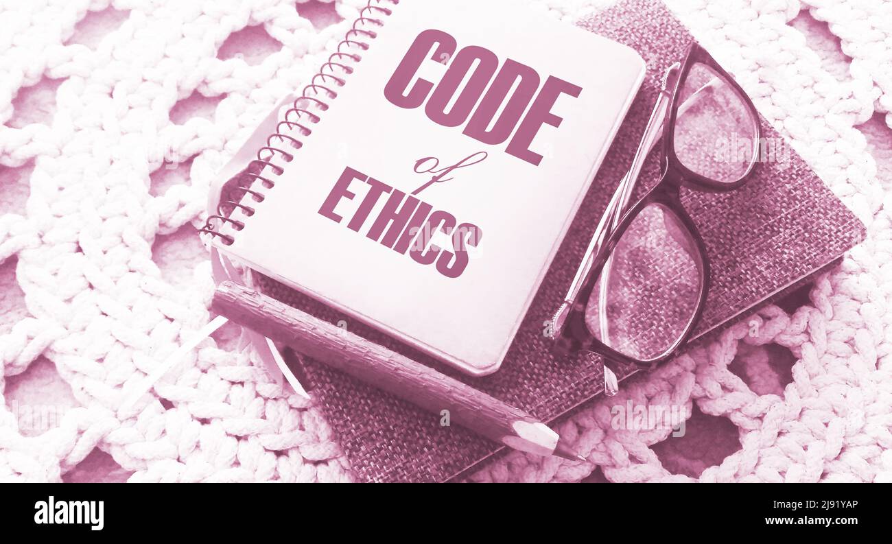 Code Of Ethics words on notebook, pen, glasses, crochet cloth. Business ...