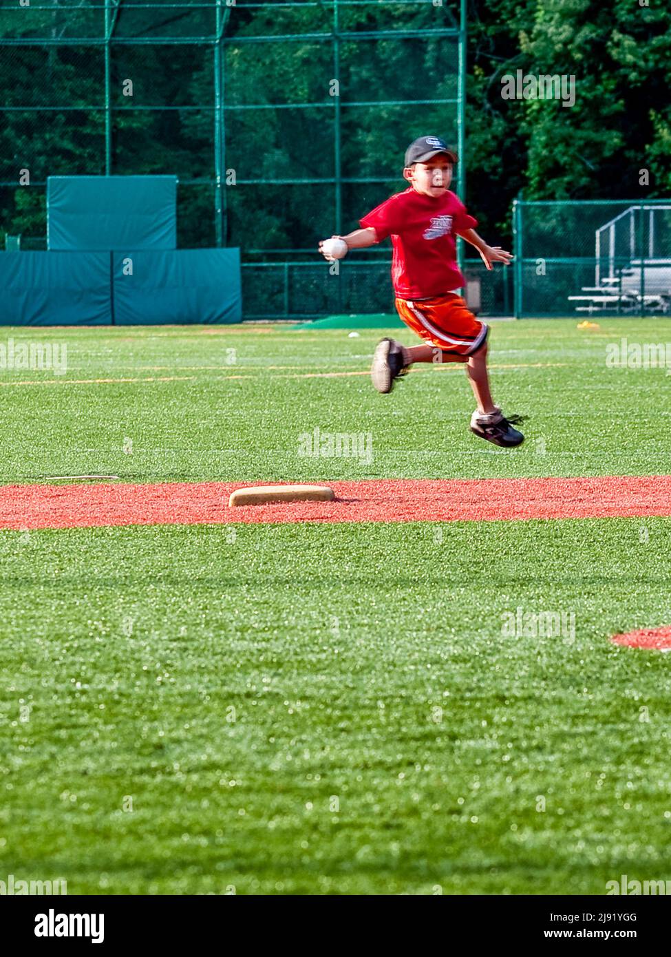 Children's baseball game baseman catches ball in midair Stock Photo - Alamy