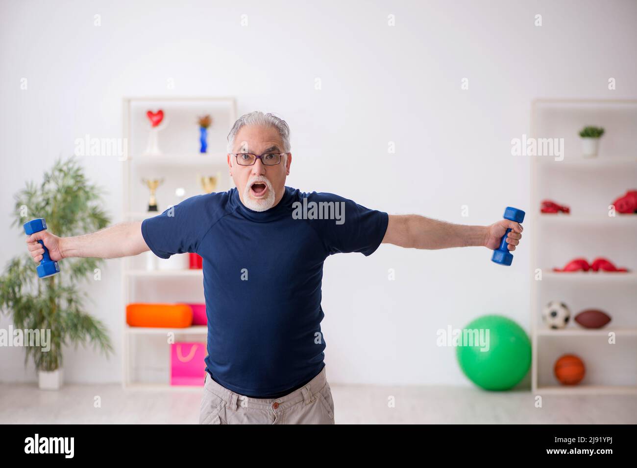Old man doing sport exercises at home Stock Photo - Alamy