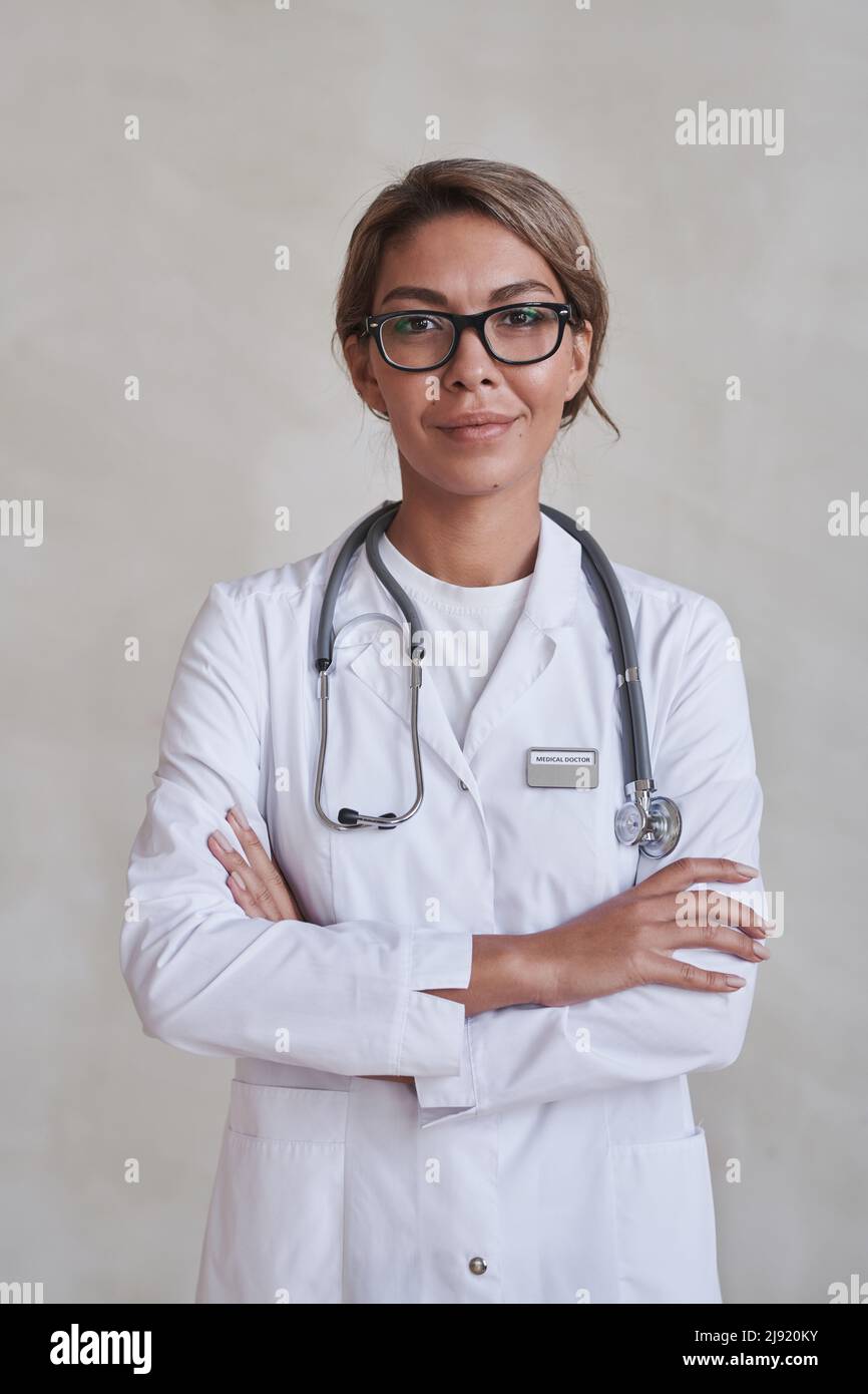 Vertical medium studio portrait of modern female doctor wearing ...