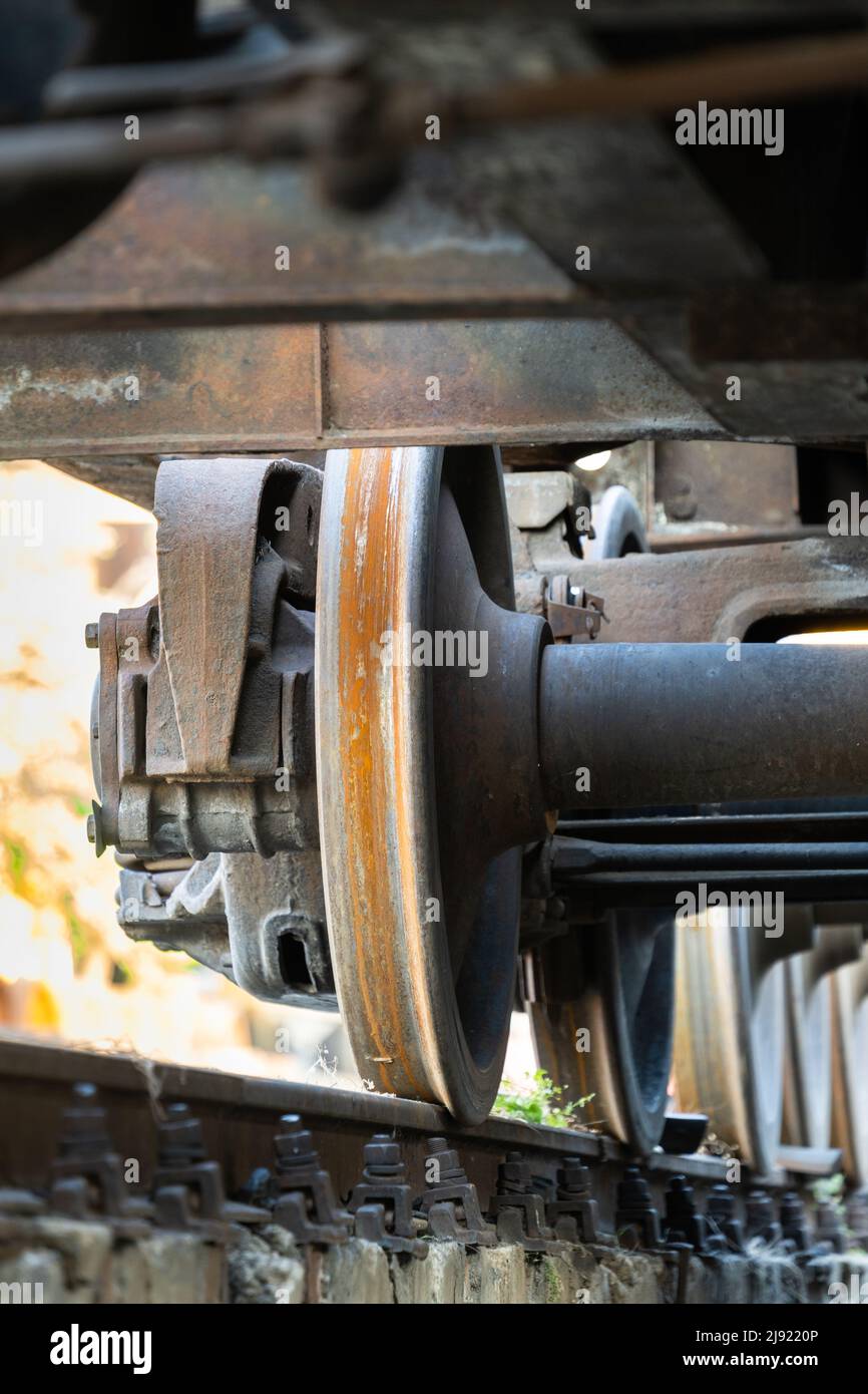 Closeup view of old rusty wheels of train. Railroad car chassis on rail ...