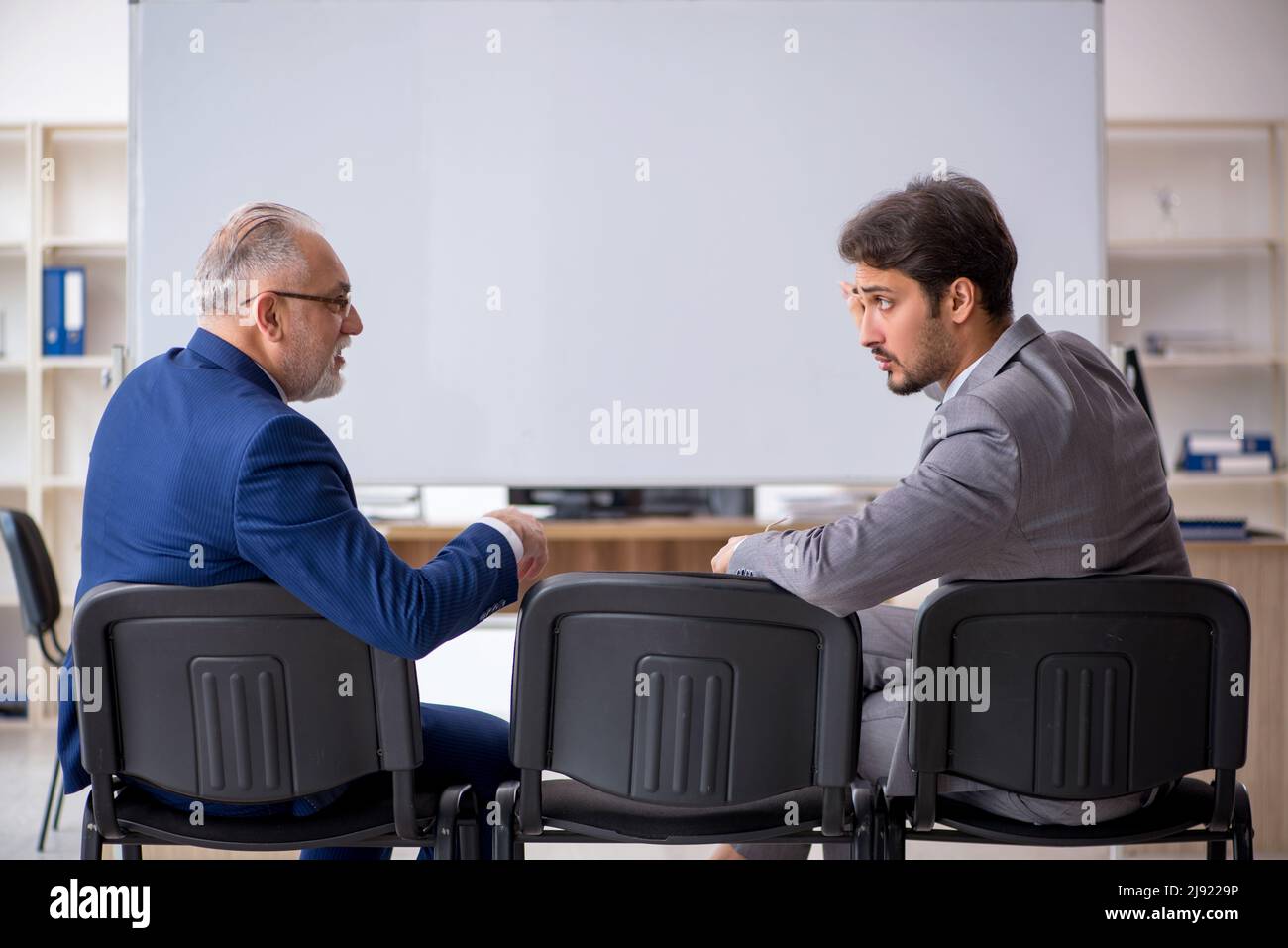 Two colleagues in business presentation concept Stock Photo - Alamy