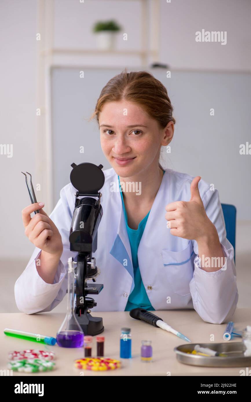 Young girl chemist in drugs synthesis concept Stock Photo - Alamy