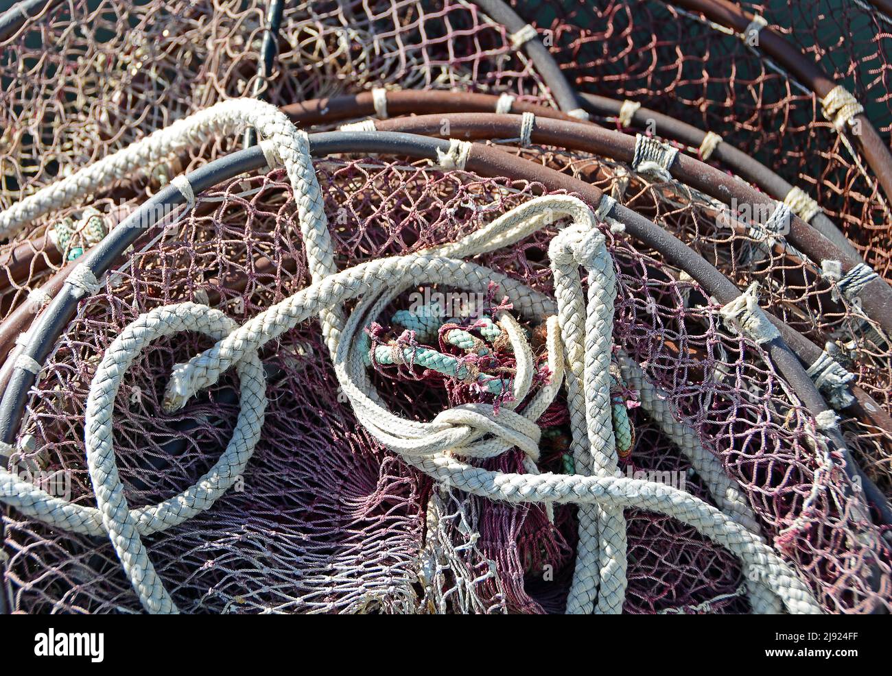 Brown fishing traps with rope Stock Photo - Alamy