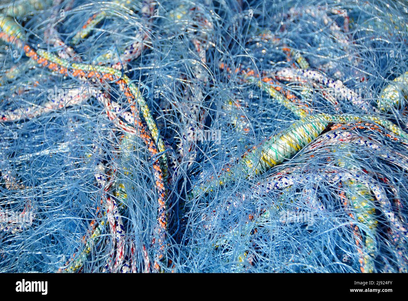 Blue fishing net with coloured rope and floats Stock Photo - Alamy
