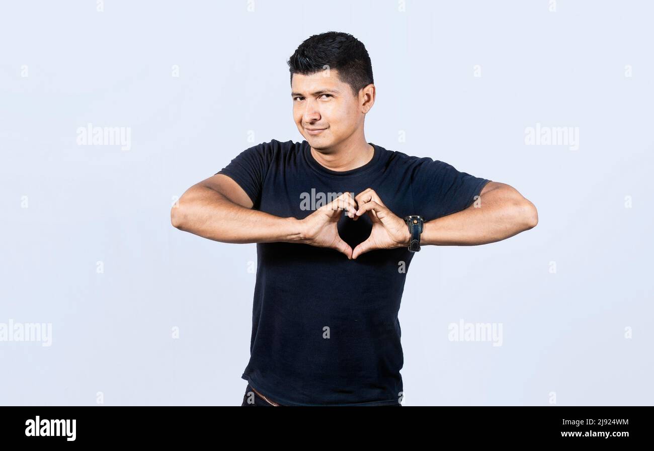 Man forming a heart with his fingers on isolated background, Person ...