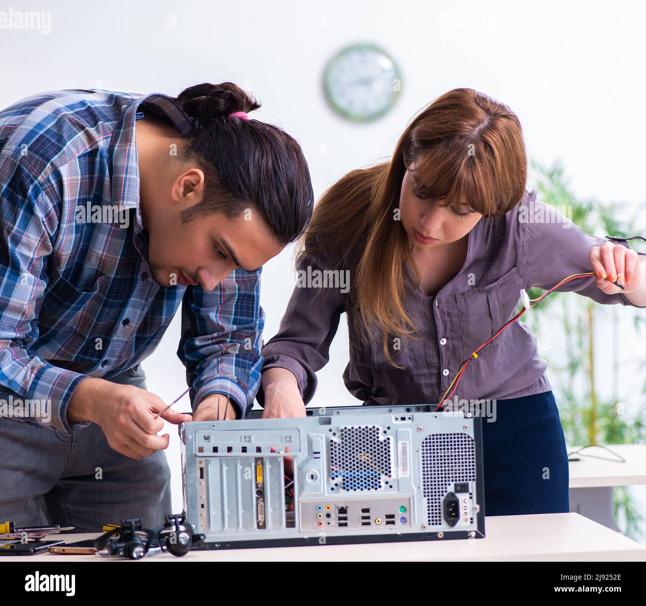 The two repairmen repairing desktop computer Stock Photo - Alamy